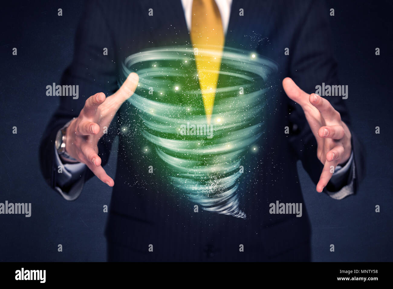 Bright green tornado in the hands of a businessman Stock Photo - Alamy