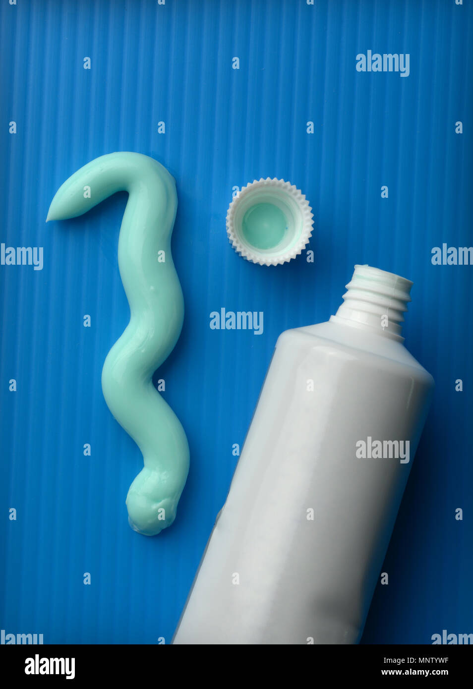 toothpaste tube on light blue background - closeup Stock Photo - Alamy