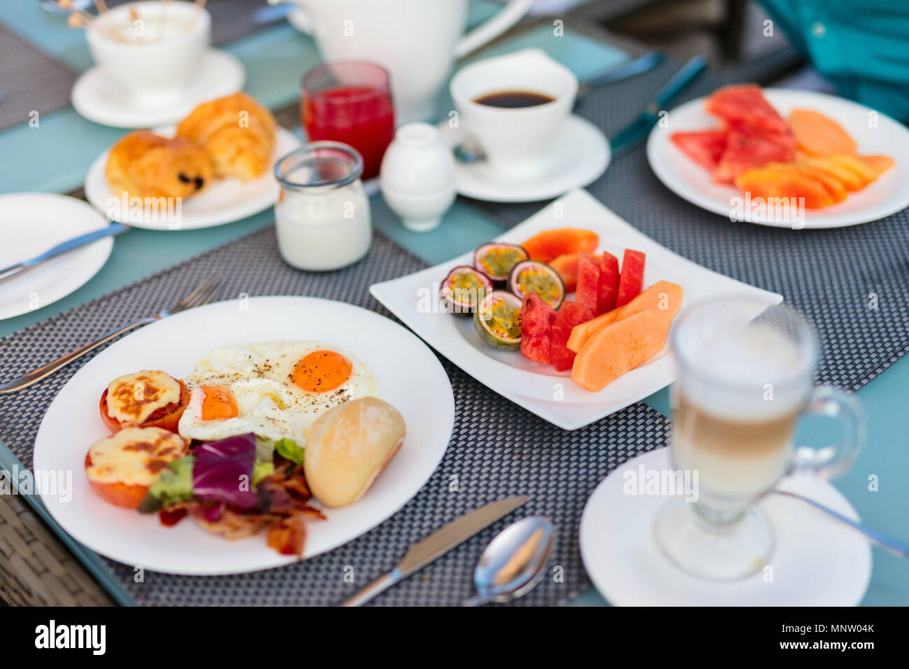 Delicious breakfast with fried eggs, bacon, vegetables and fruits Stock ...