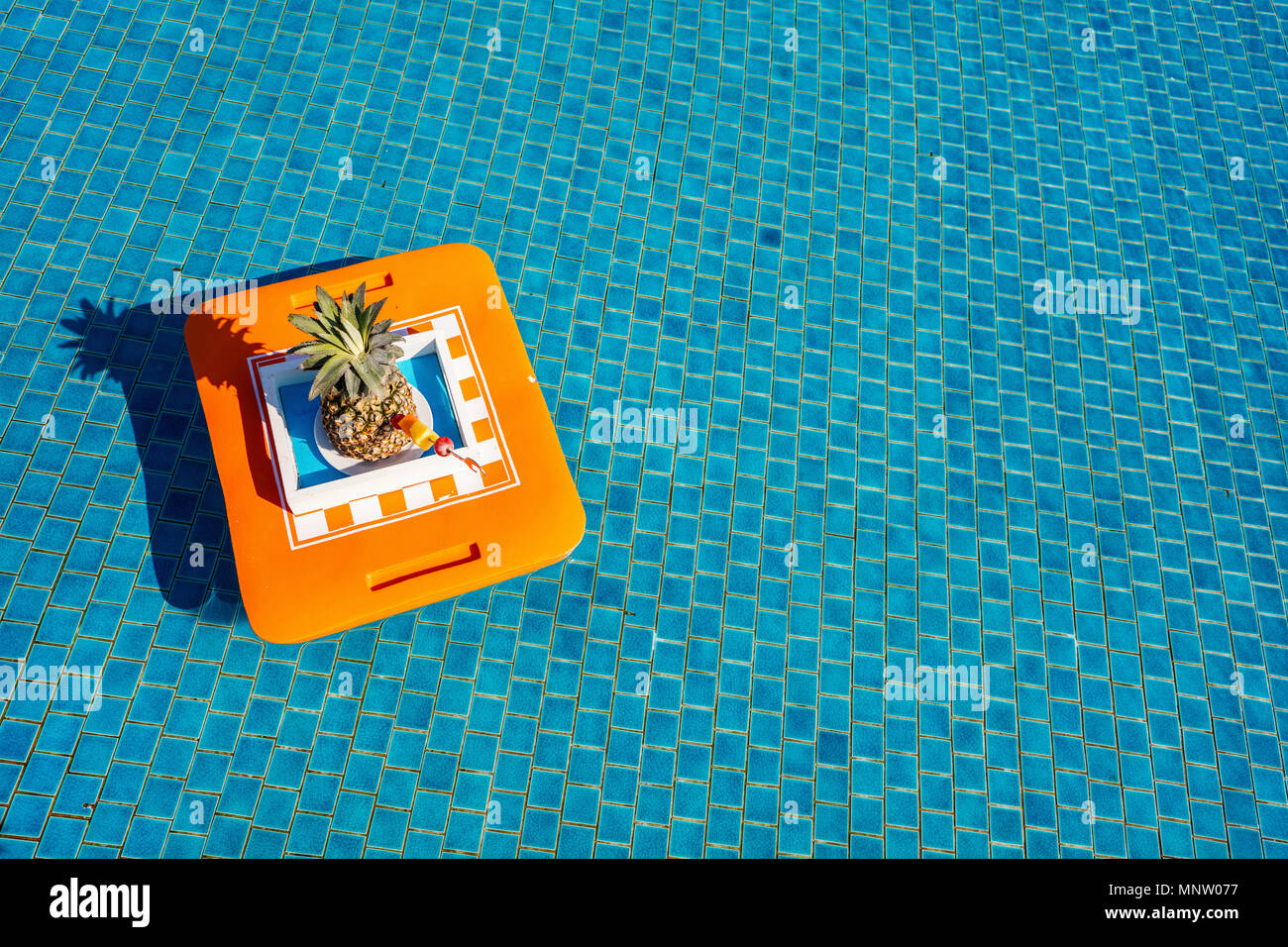 Tropical cocktail in pineapple shell floating at pool Stock Photo - Alamy