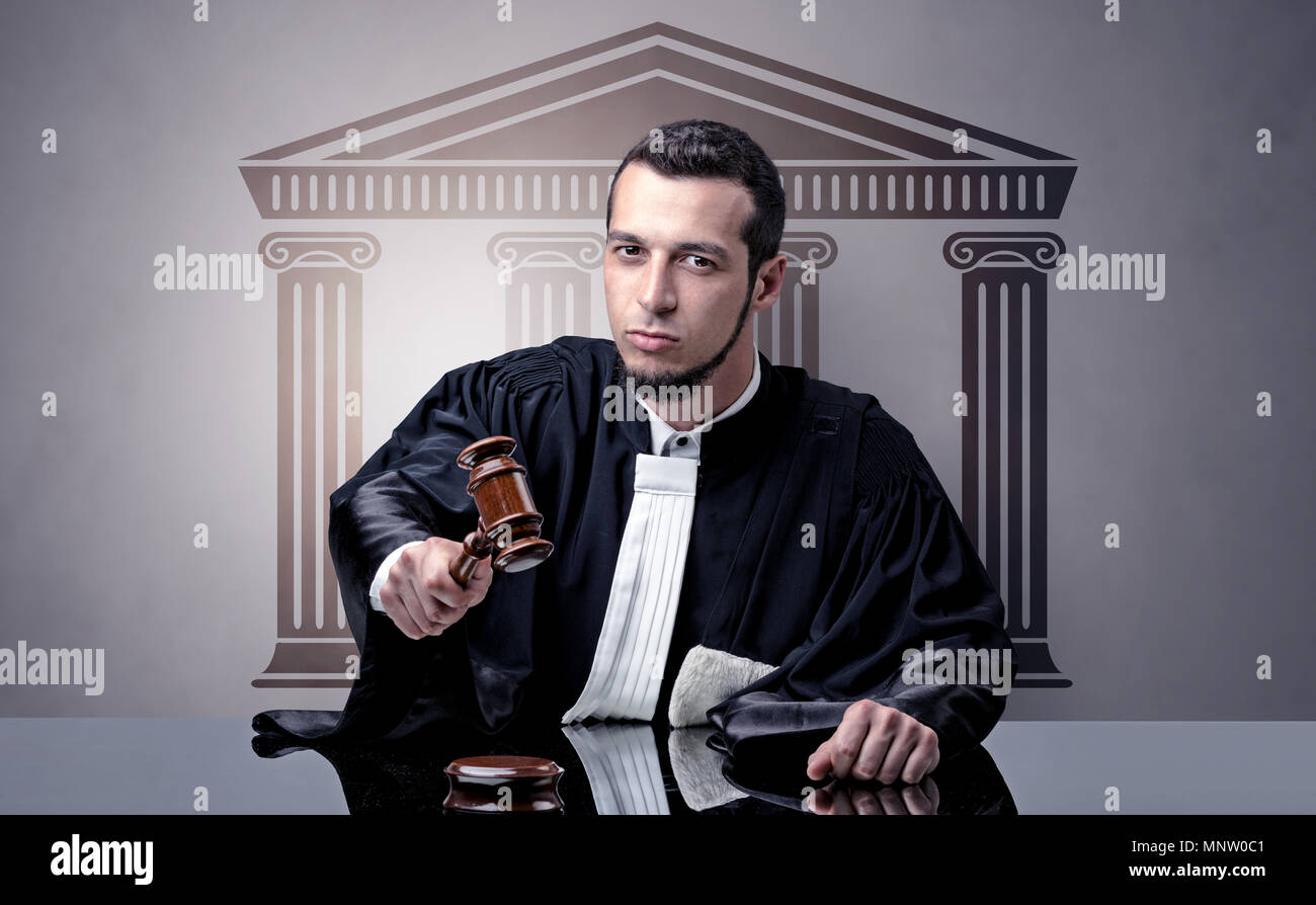 Young judge in front of a courthouse symbol making decision Stock Photo ...
