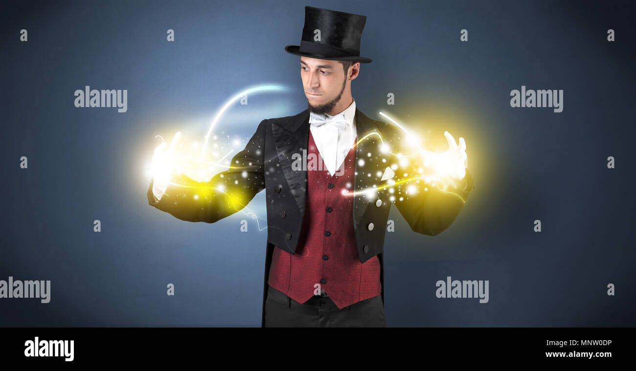 Magician holding his sparkling power between his two hand Stock Photo ...