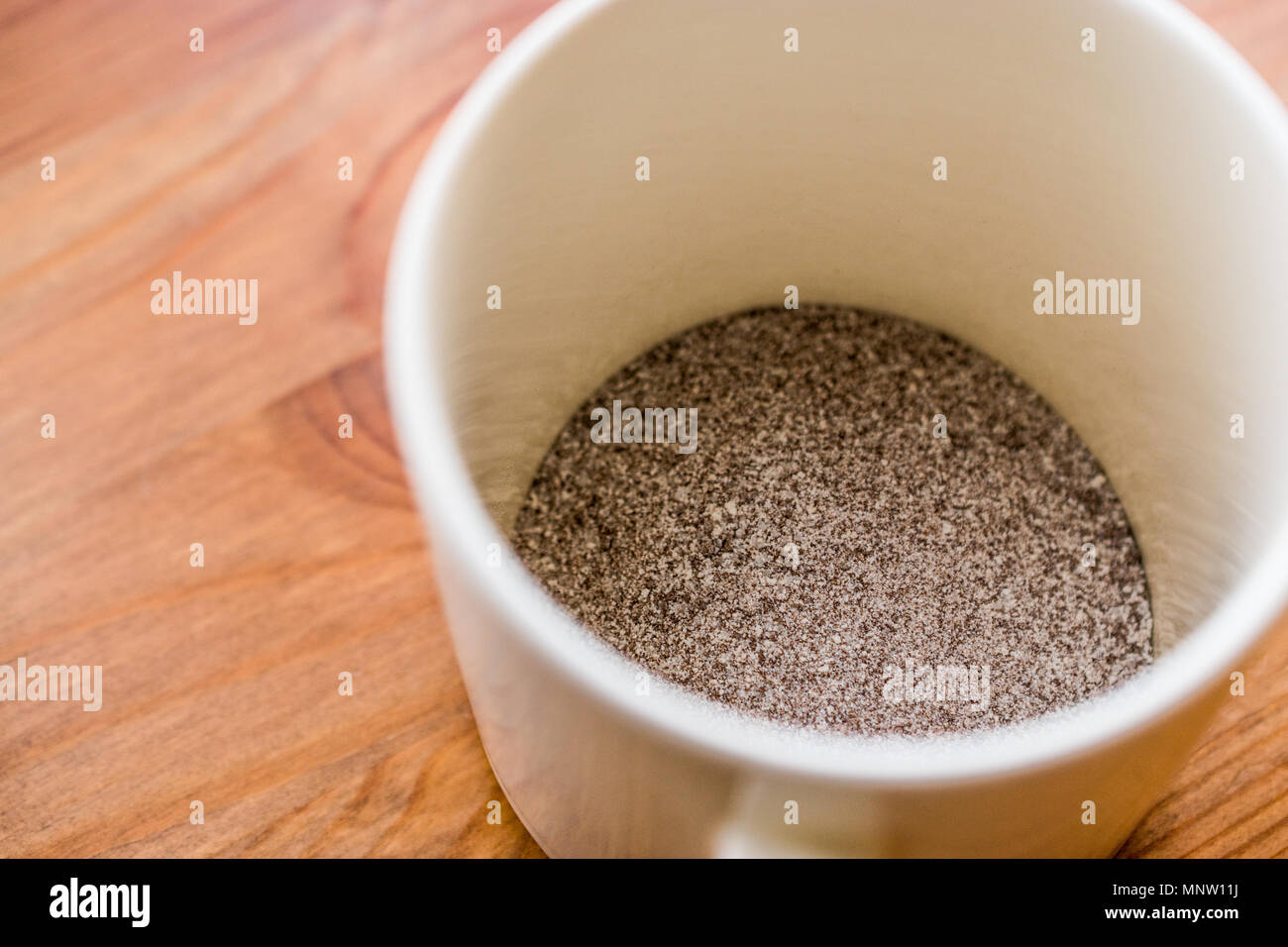 instant coffee powder 3 in 1; mixed with milk powder and sugar in a cup ...