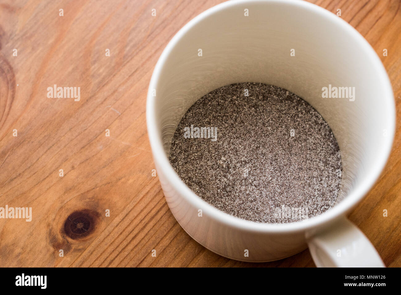 instant coffee powder 3 in 1; mixed with milk powder and sugar in a cup ...