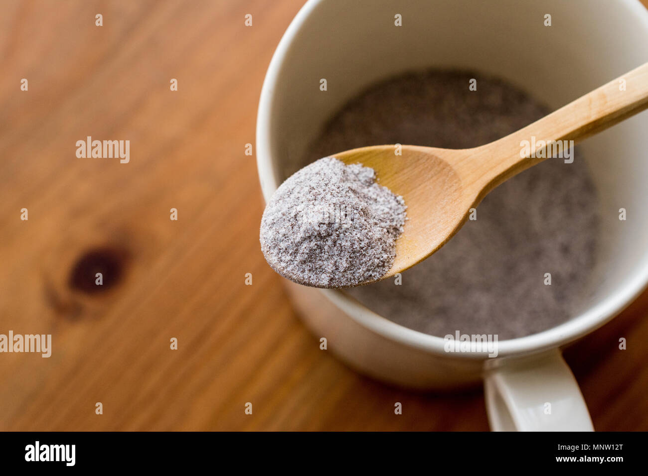 instant coffee powder 3 in 1; mixed with milk powder and sugar in a cup ...