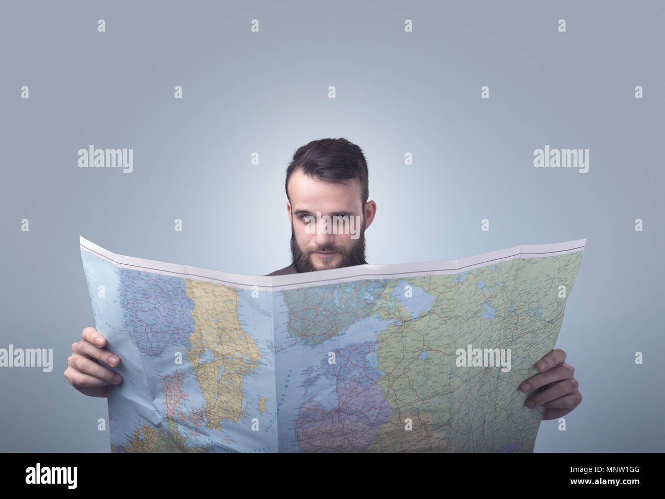 Handsome young man holding map Stock Photo - Alamy