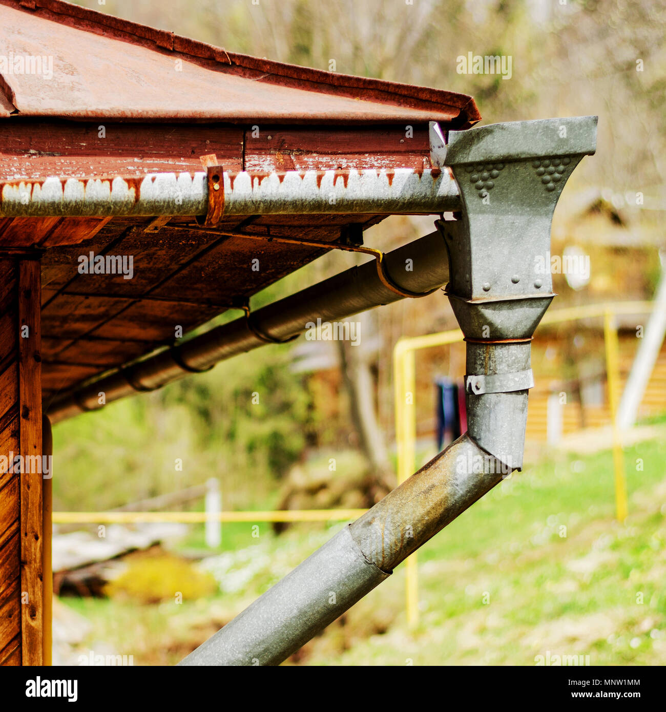 Gutters in old-fashioned rustic wooden house and a system of water ...