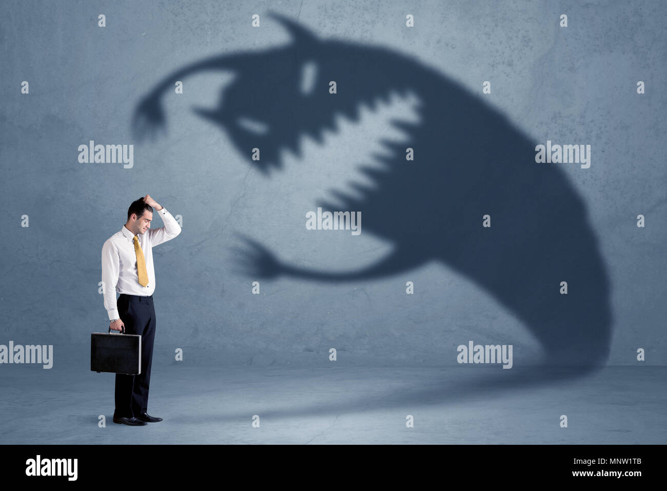 Business man afraid of his own shadow monster concept on grungy ...