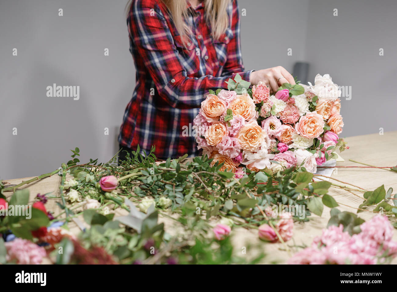 Female florist. Floral workshop - woman making a beautiful flower ...