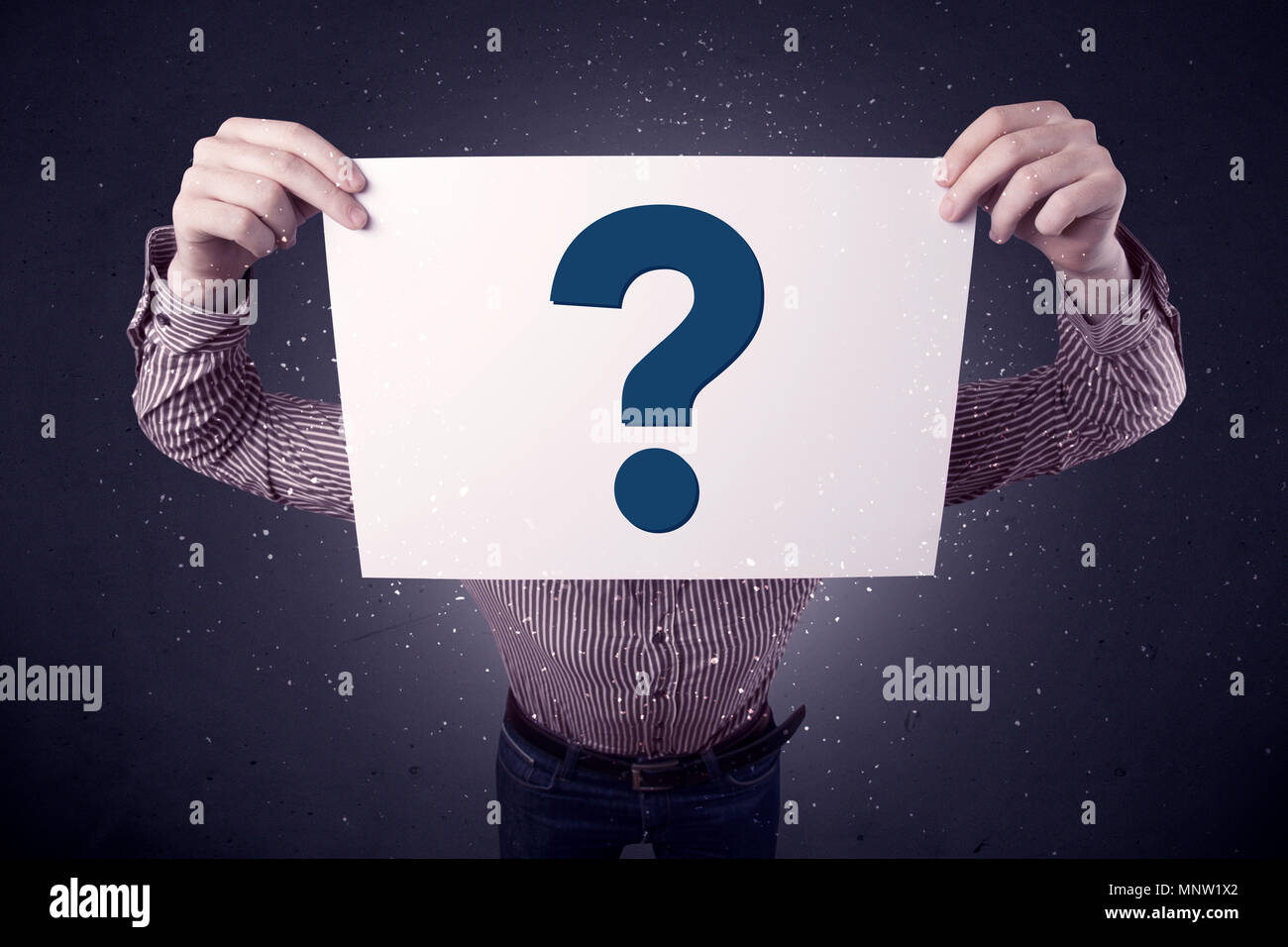 Young businessman hiding behind a question mark drawn on paper Stock ...