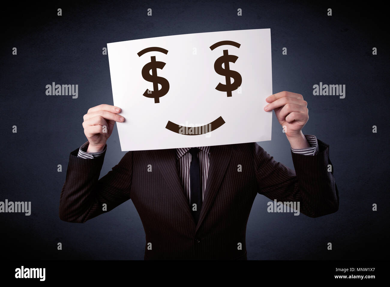 Young casual businessman hiding behind a greedy face drawing on ...