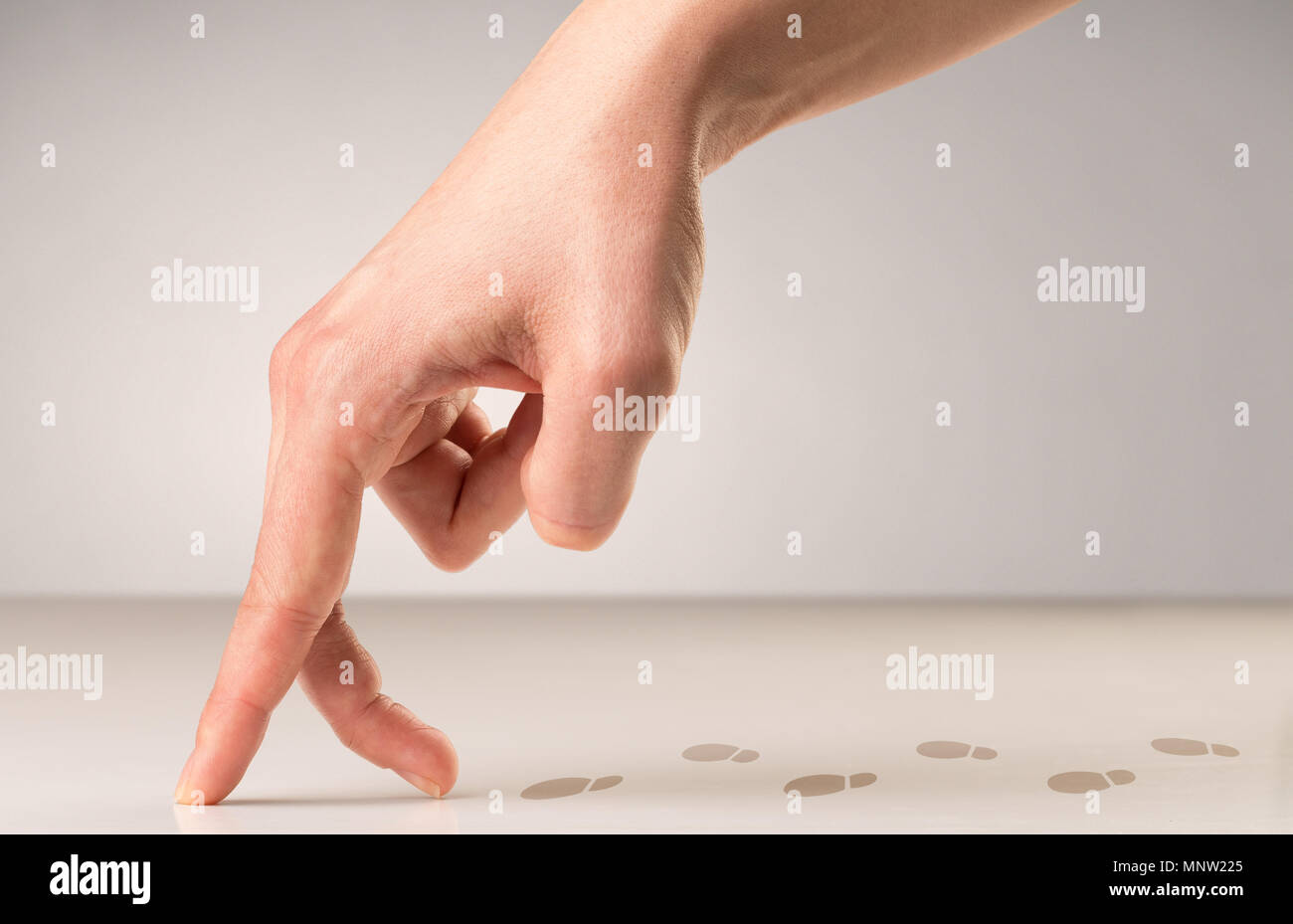 Female fingers walking on white surface with footsteps behind it Stock ...