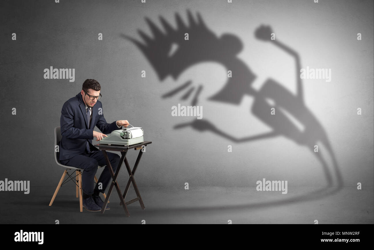 Man working hard and he is afraid of a yelling shadow Stock Photo - Alamy