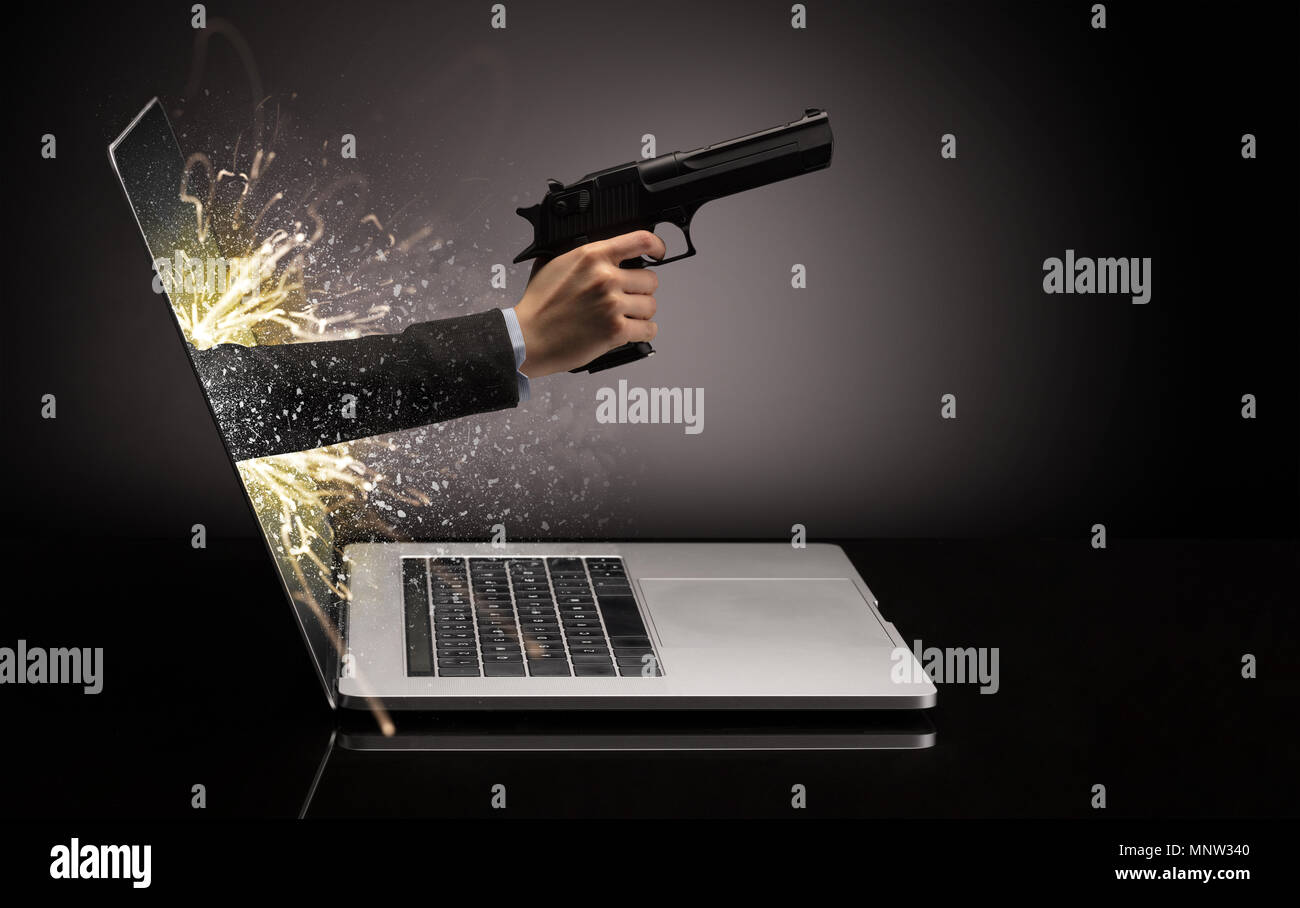 Hand with gun coming out of a laptop with sparkling effects Stock Photo ...