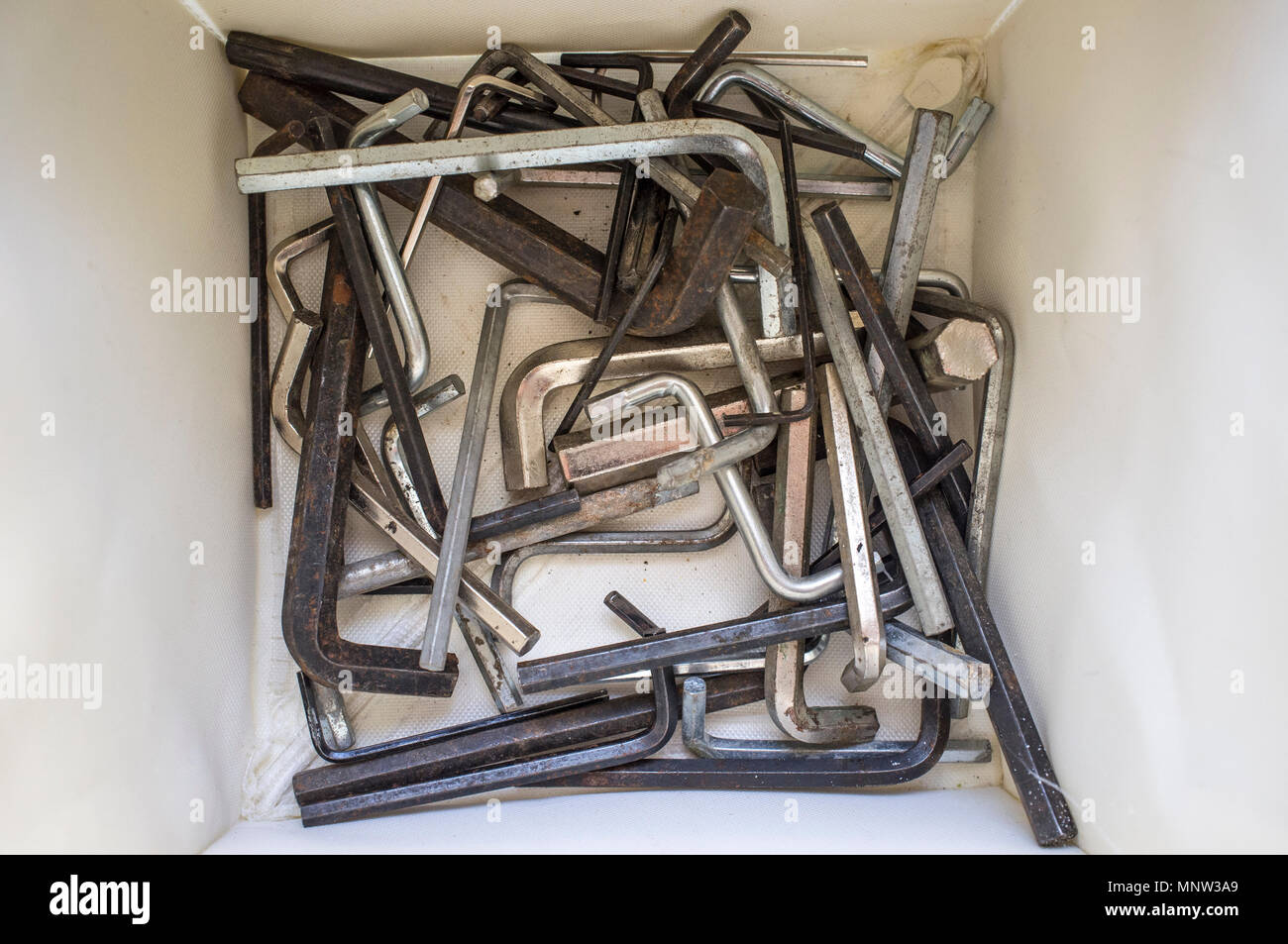 Box full of used hex keys for end-user assembly furniture. Closeup ...