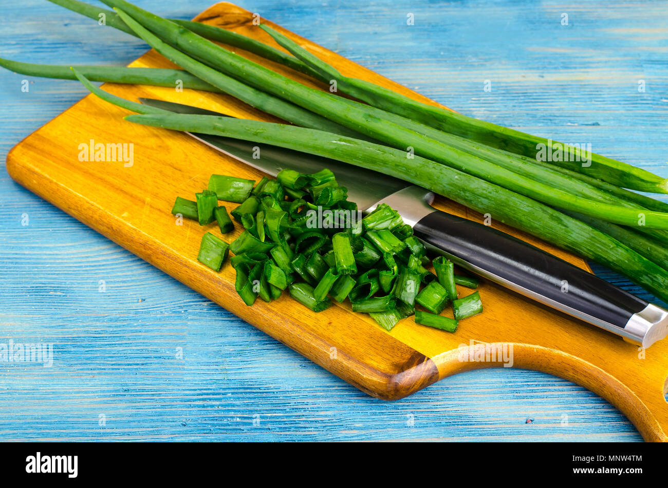 Fresh green onions cut on kitchen board. Studio Photo Stock Photo - Alamy
