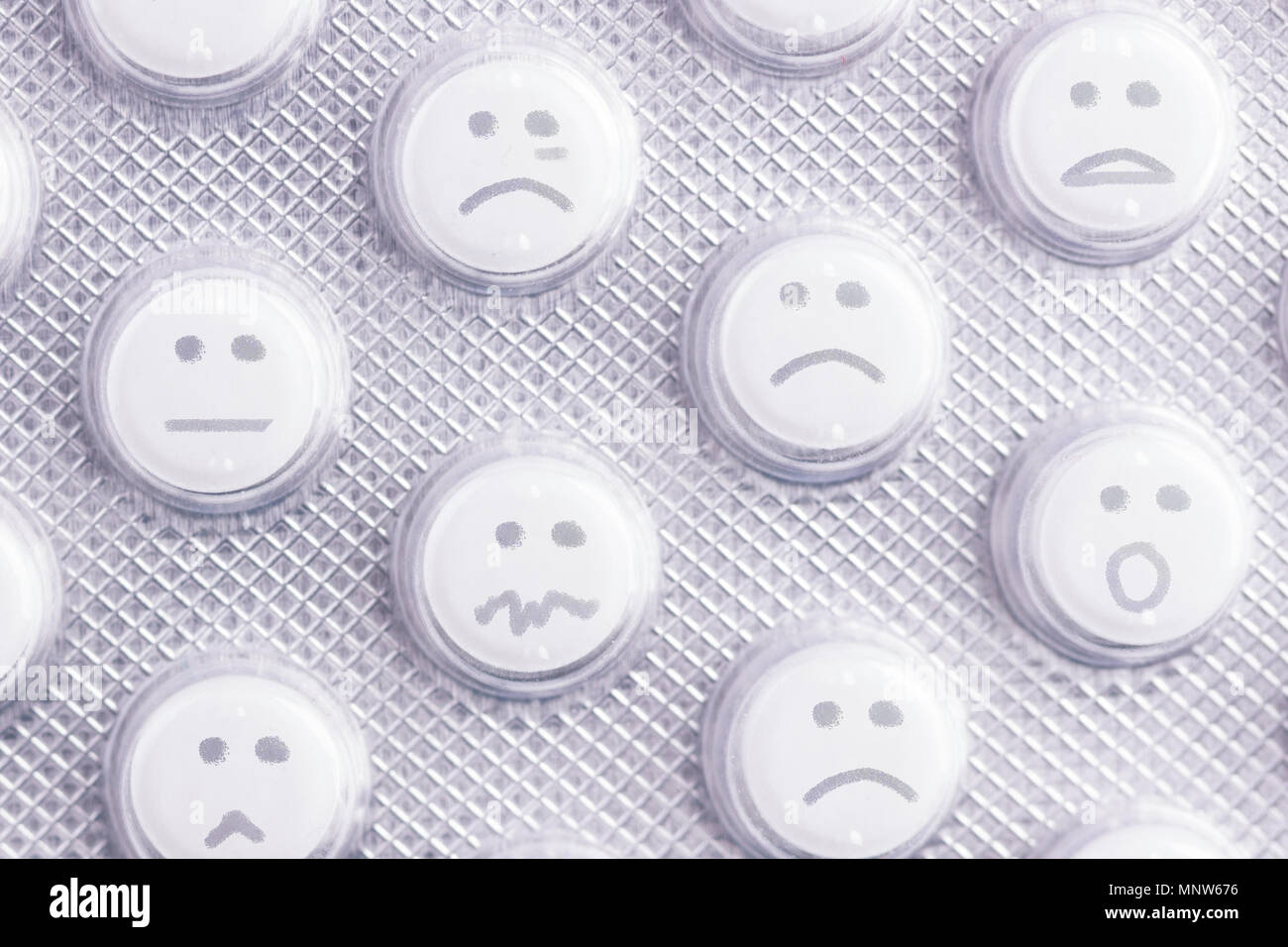 Sad face of pills. negative side effects of drugs Stock Photo - Alamy
