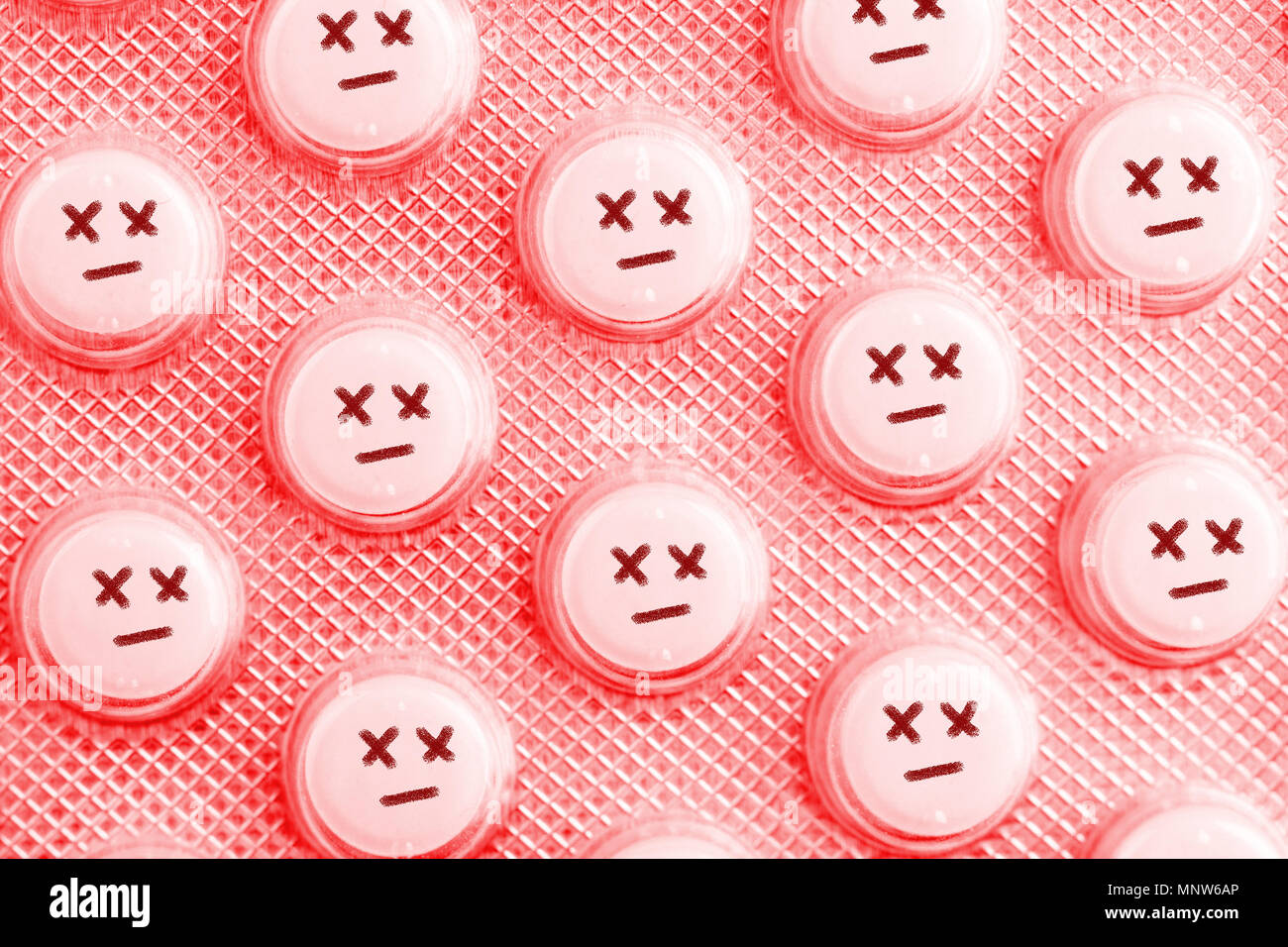 Dangerous pills with dead face on it Stock Photo - Alamy