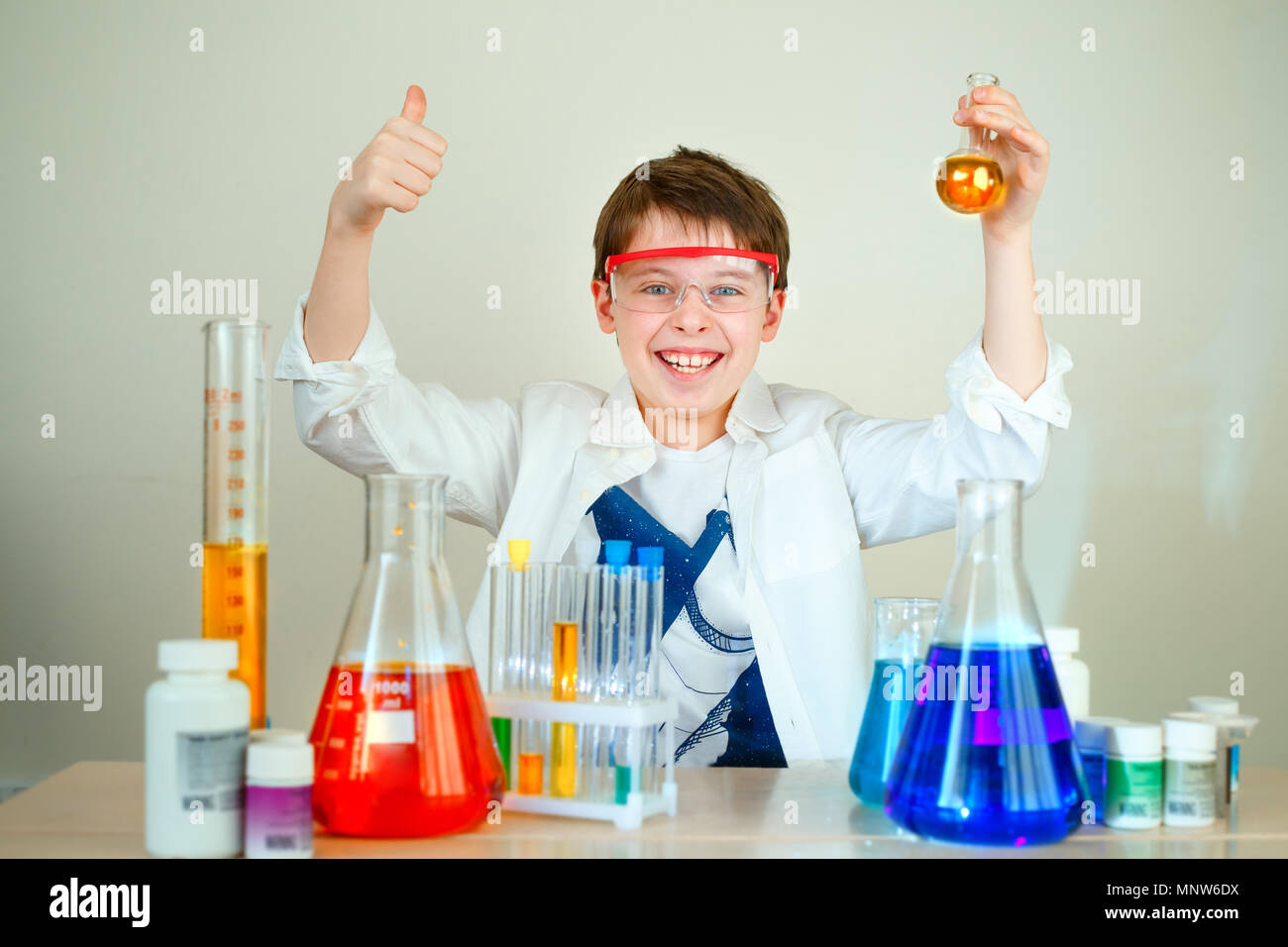 Cute boy is making science experiments in a laboratory. Education Stock ...