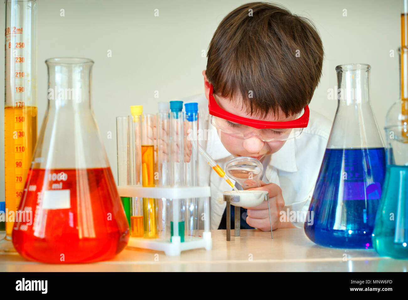 Cute boy is making science experiments in a laboratory. Education Stock ...
