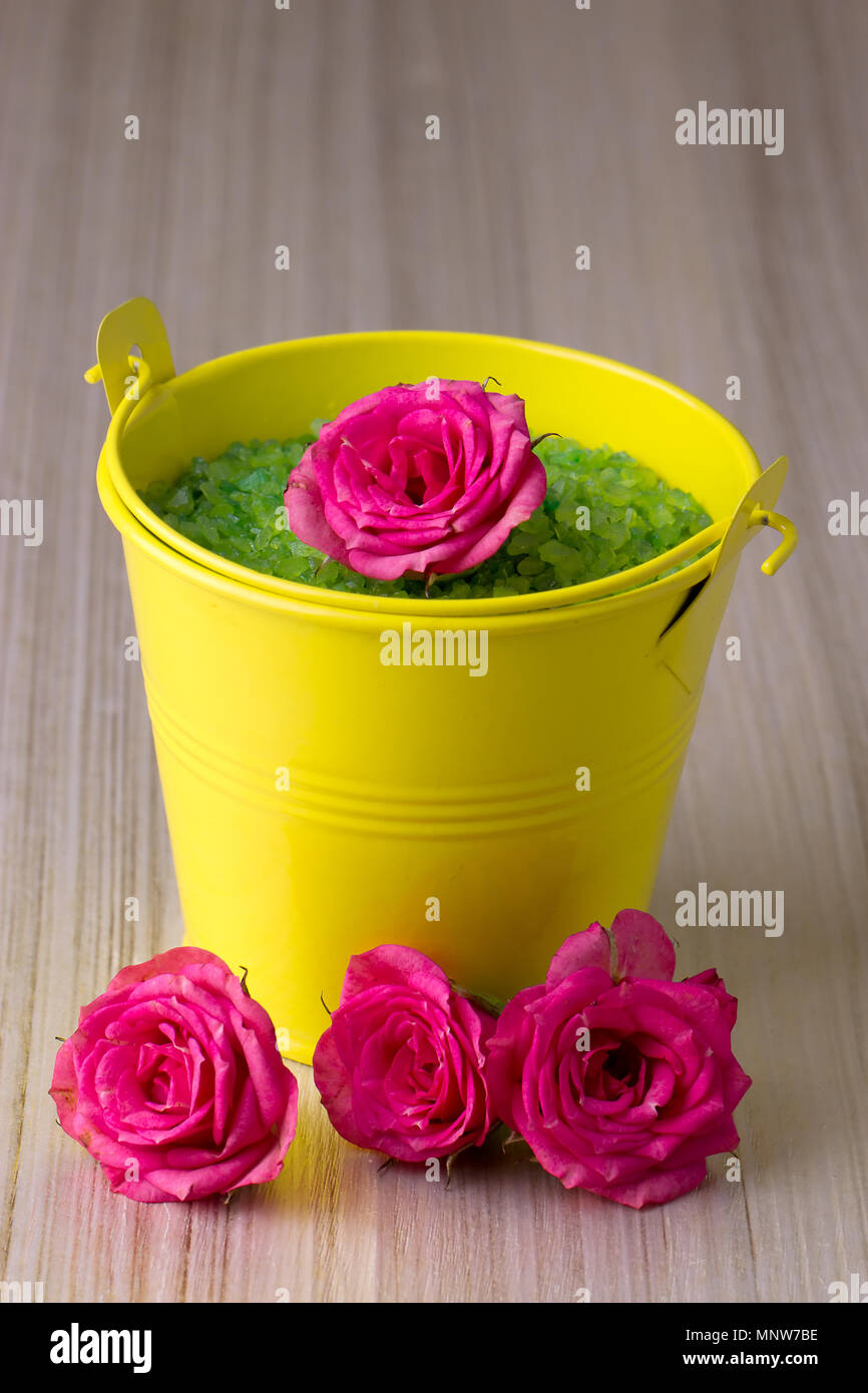 Small yellow bucket with a green sea salt Stock Photo - Alamy