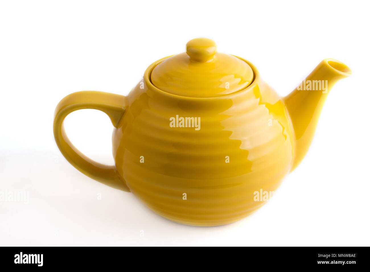 Yellow teapot on a white background Stock Photo - Alamy