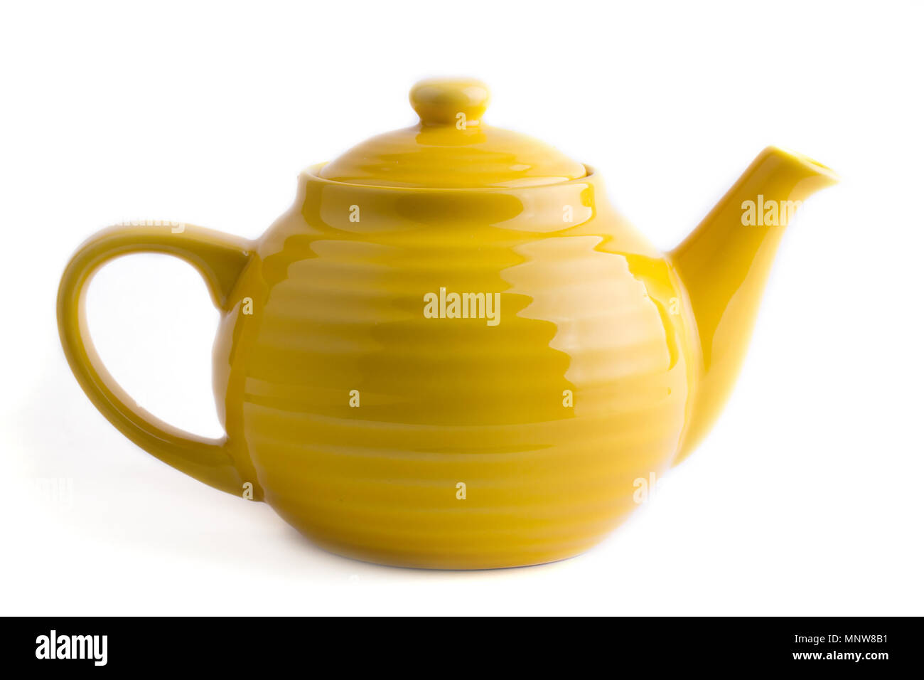 Yellow teapot for tea on a white background Stock Photo - Alamy