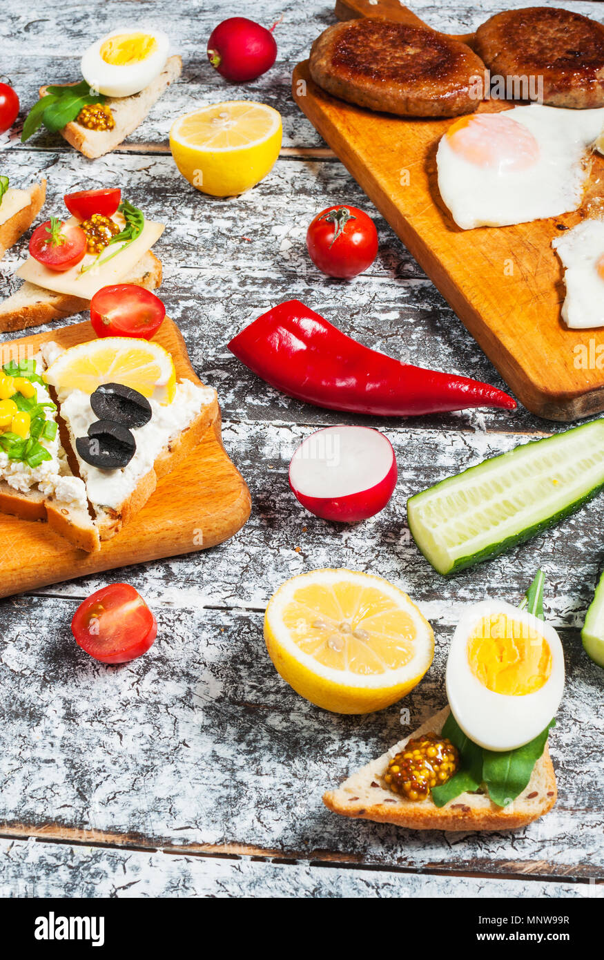 Variety of open sandwiches with different toppings on white backdrop ...