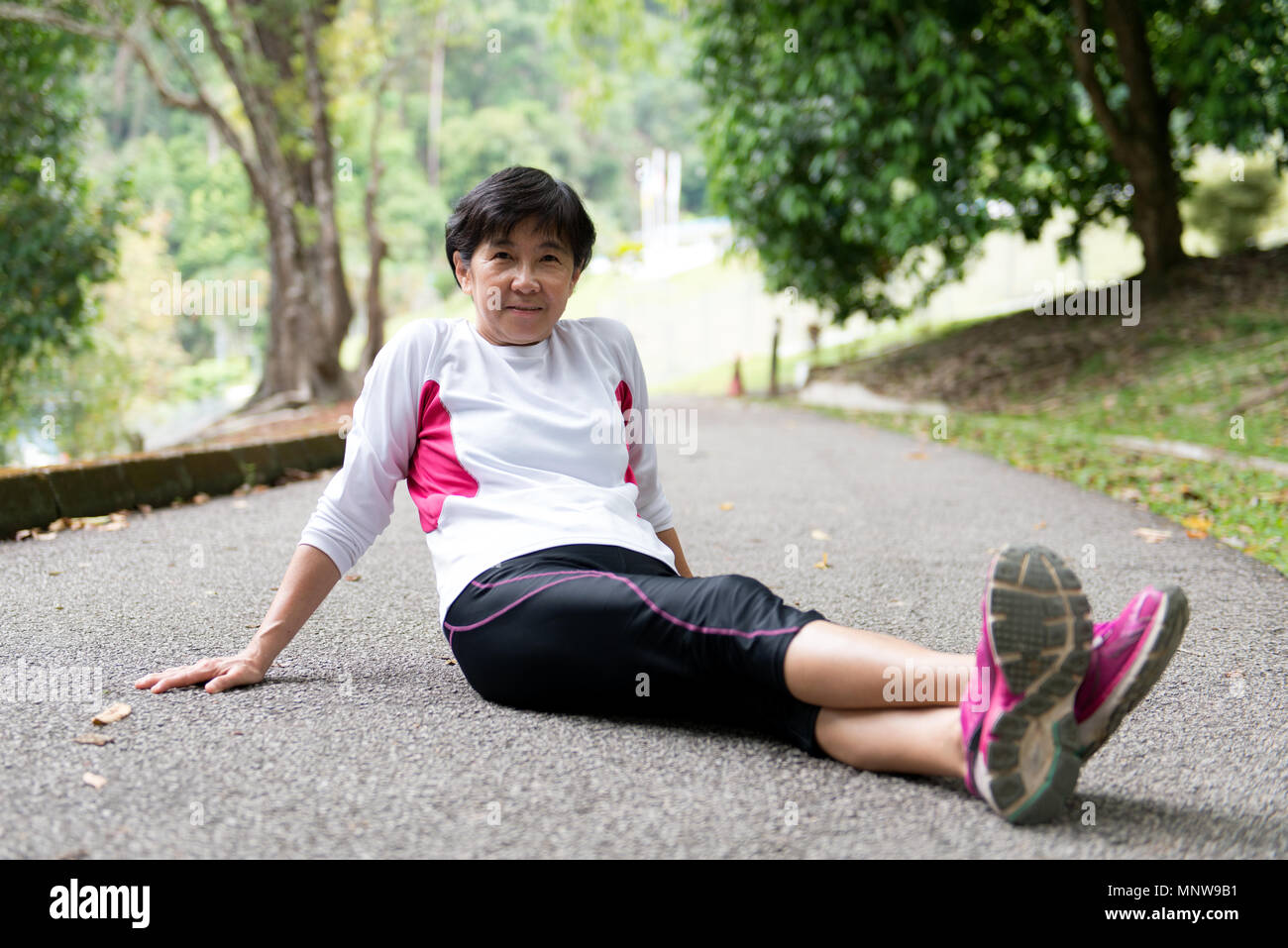 Senior woman resting after jogging Stock Photo - Alamy