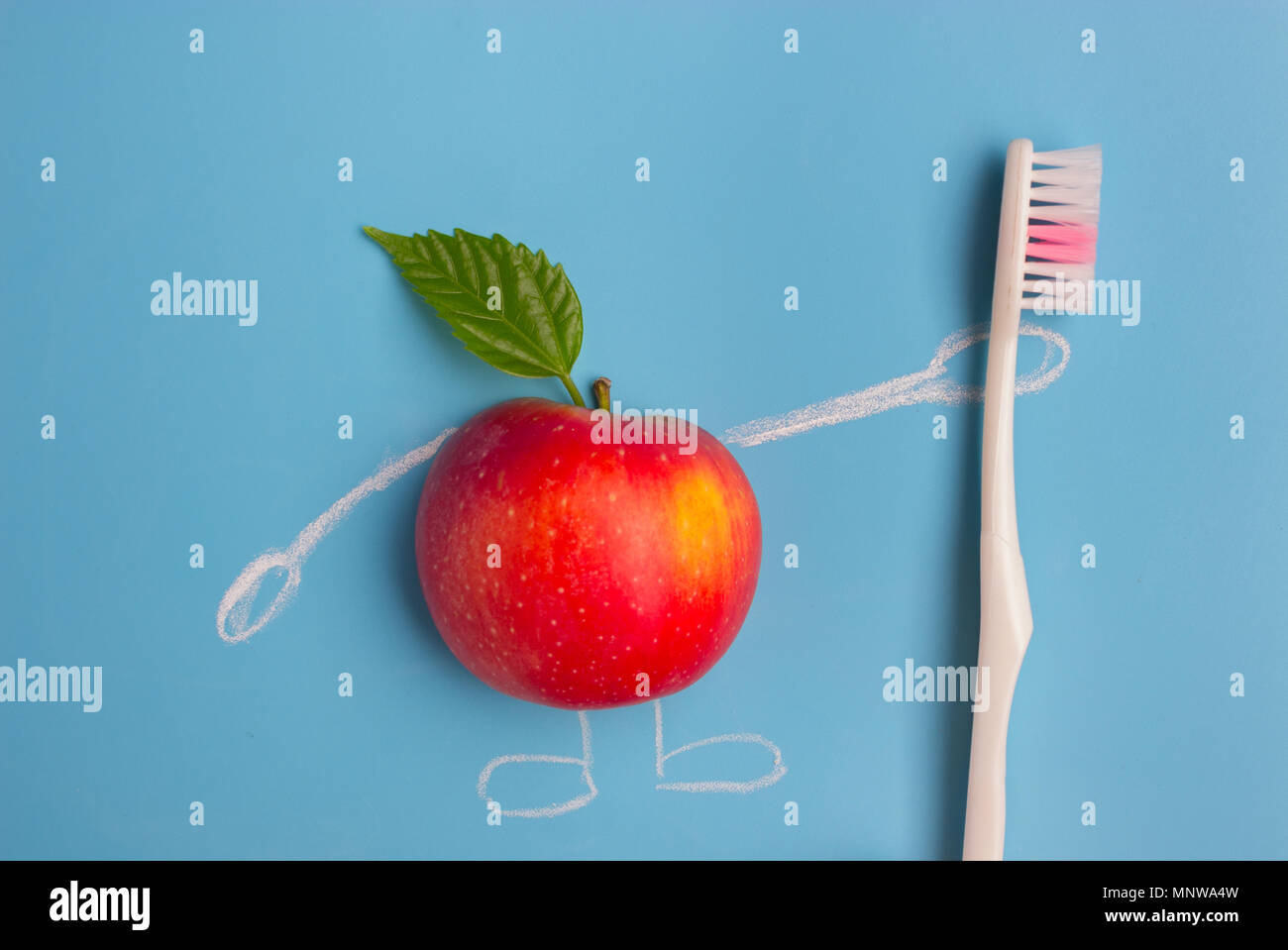 apple character holding a toothbrush on blue background Stock Photo - Alamy