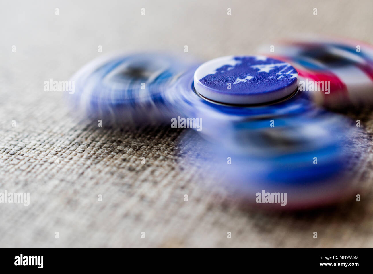 Fidget Spinner on a grey surface. Toy Concept Stock Photo - Alamy