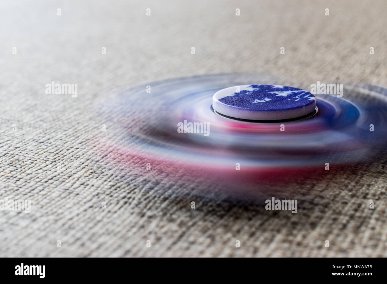 Fidget Spinner on a grey surface. Toy Concept Stock Photo - Alamy