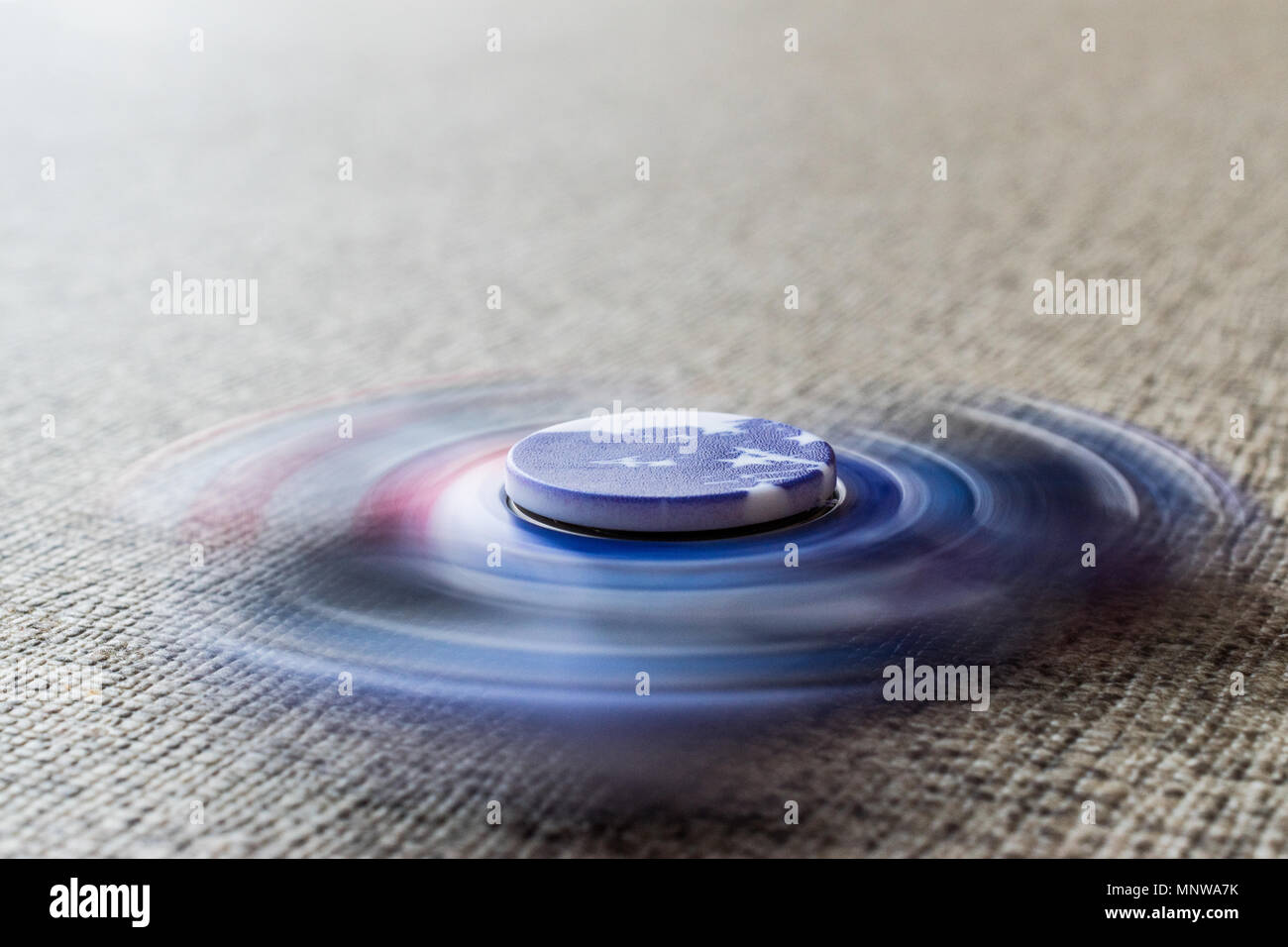 Fidget Spinner on a grey surface. Toy Concept Stock Photo - Alamy