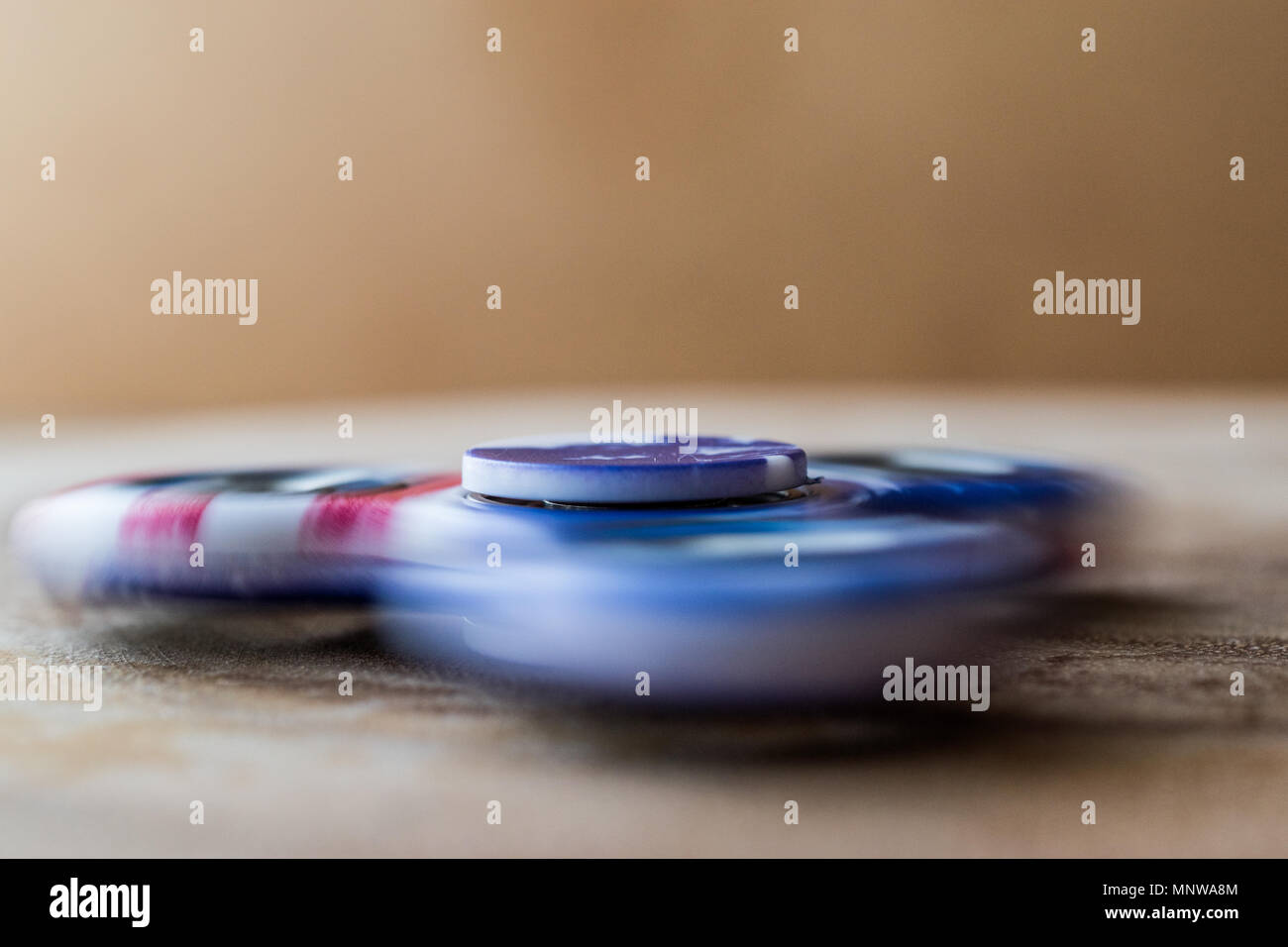 Fidget Spinner on a grey surface. Toy Concept Stock Photo - Alamy