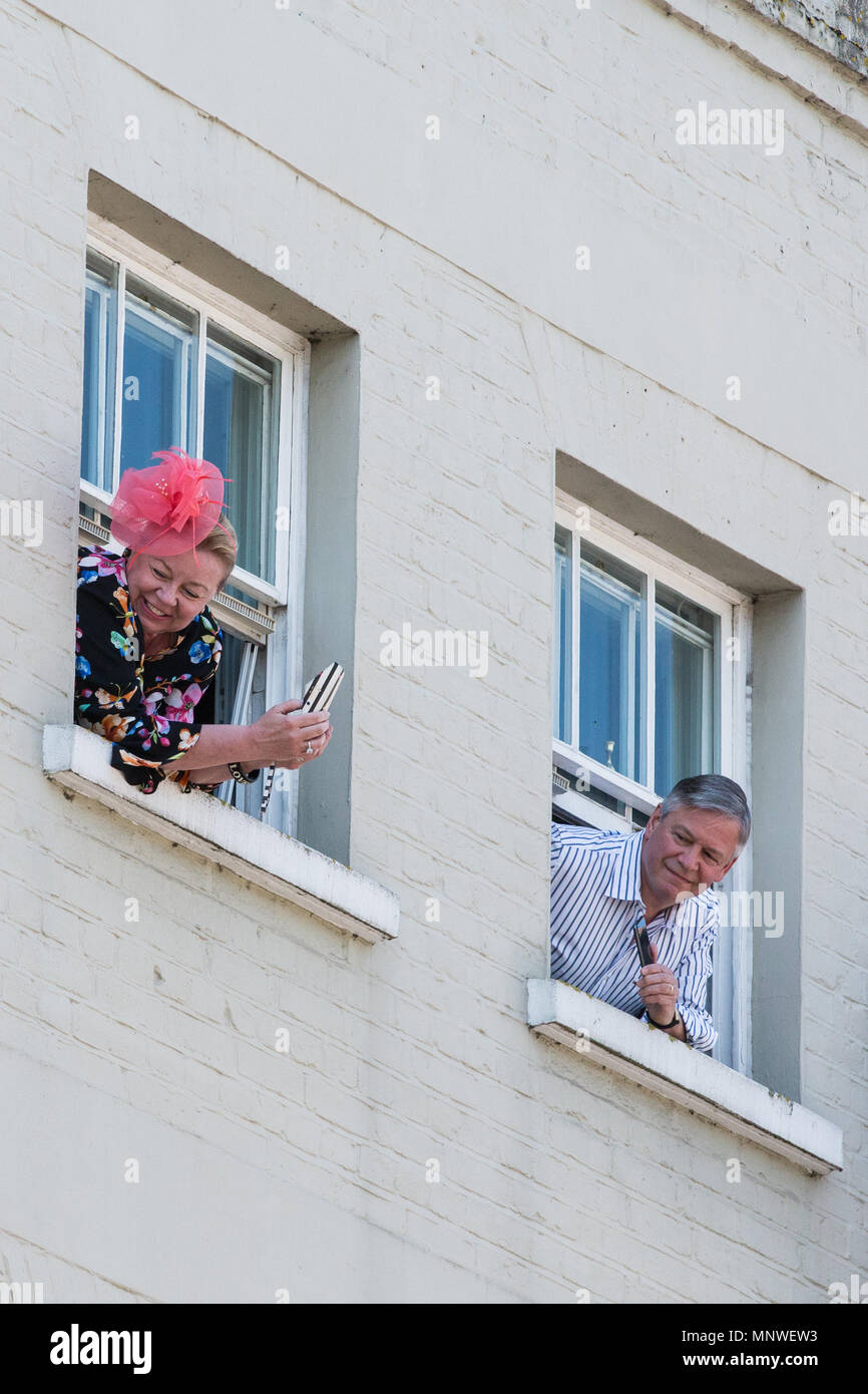Windsor, UK. 19th May, 2018. Well-wishers look out of windows above the ...