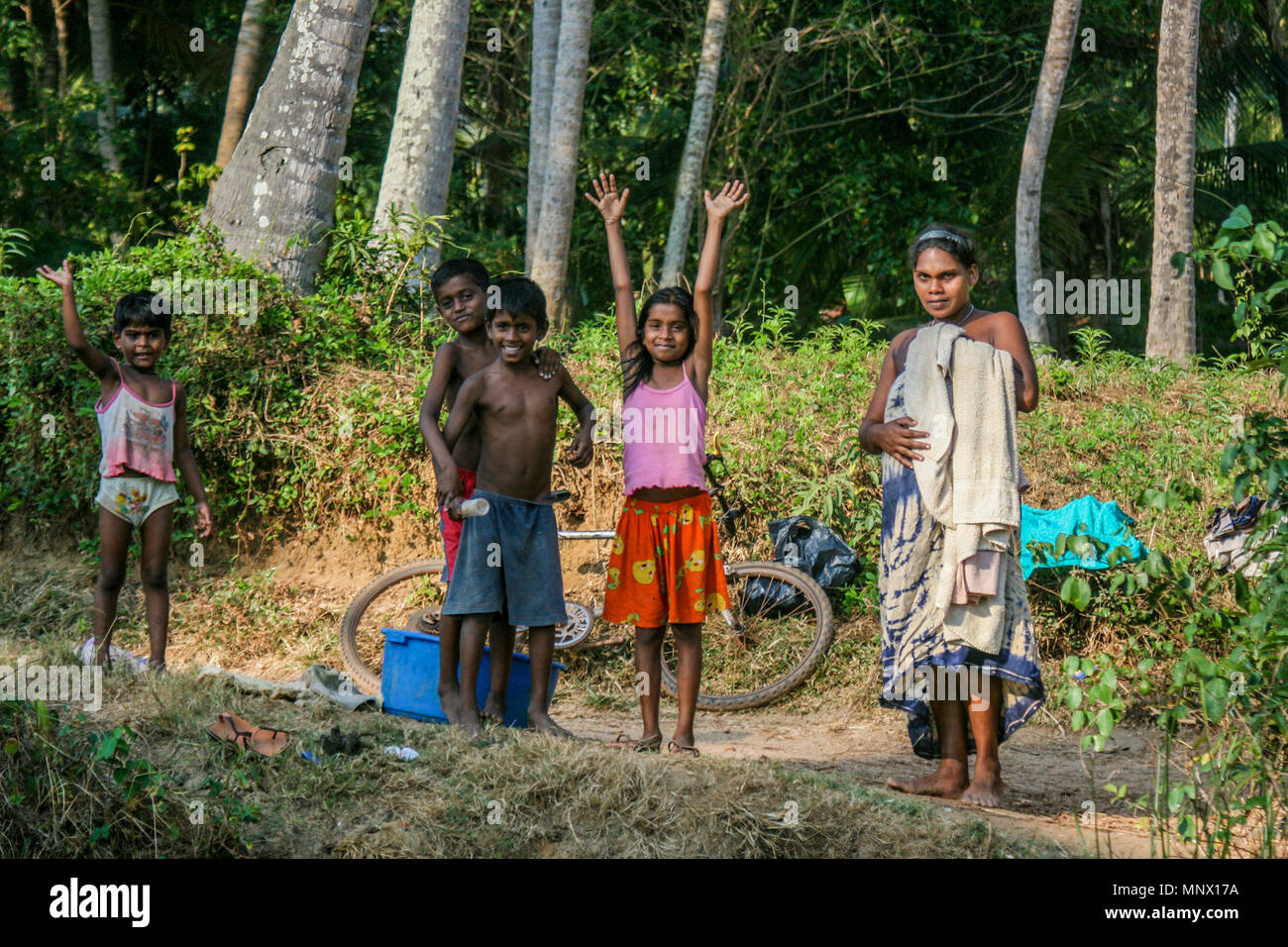Children standing by the riverbank near their village in Sri Lanka ...