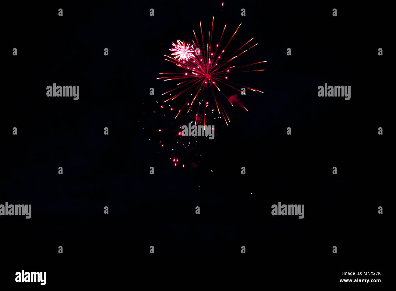 Red flashes of fireworks in the night sky Stock Photo - Alamy