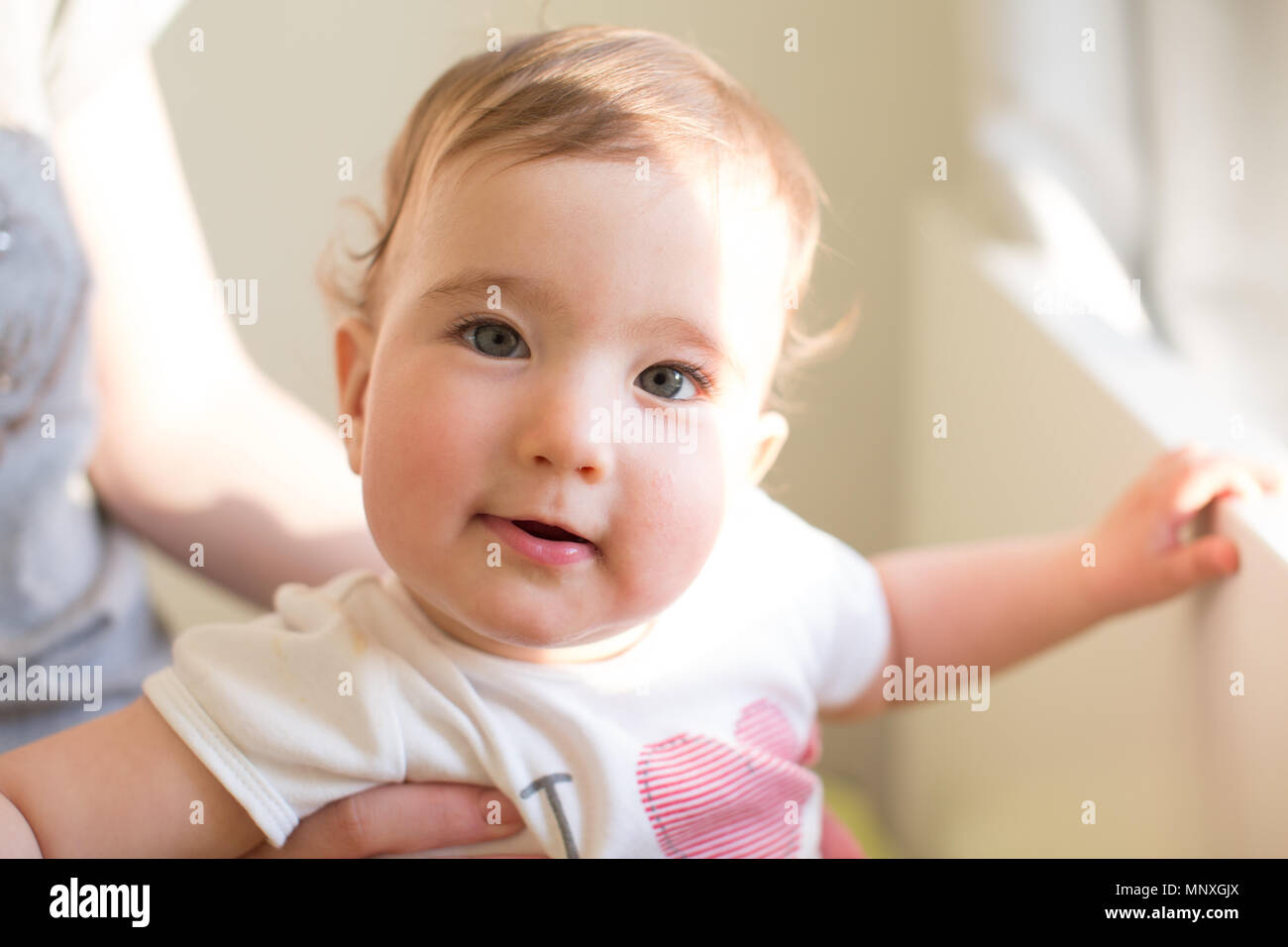 happy and small child near the window Stock Photo - Alamy