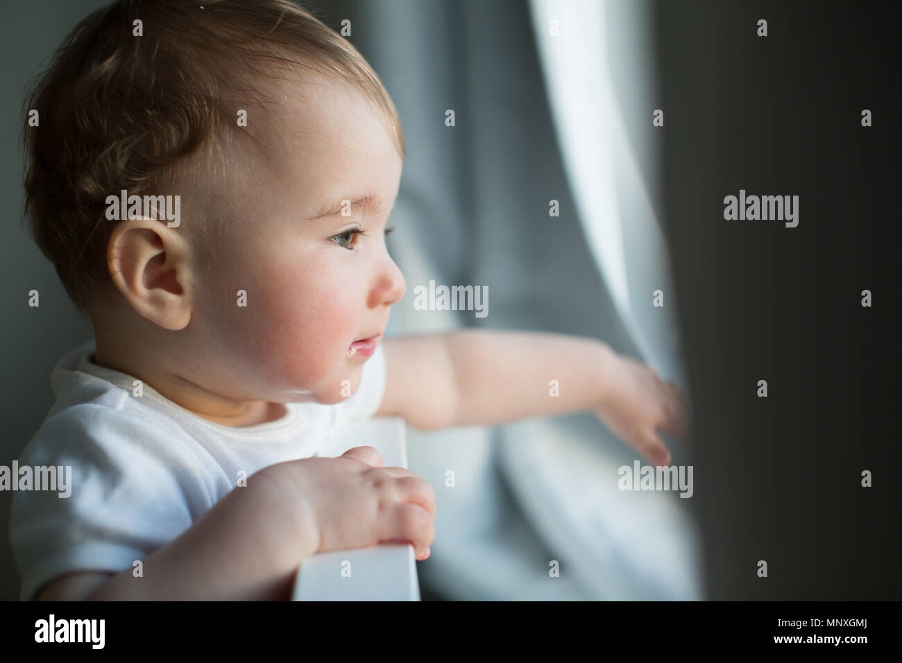 happy and small child near the window Stock Photo - Alamy