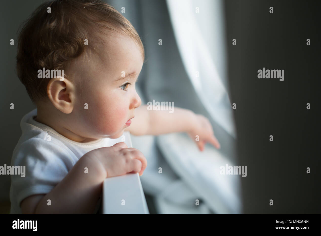 Baby near window hi-res stock photography and images - Alamy