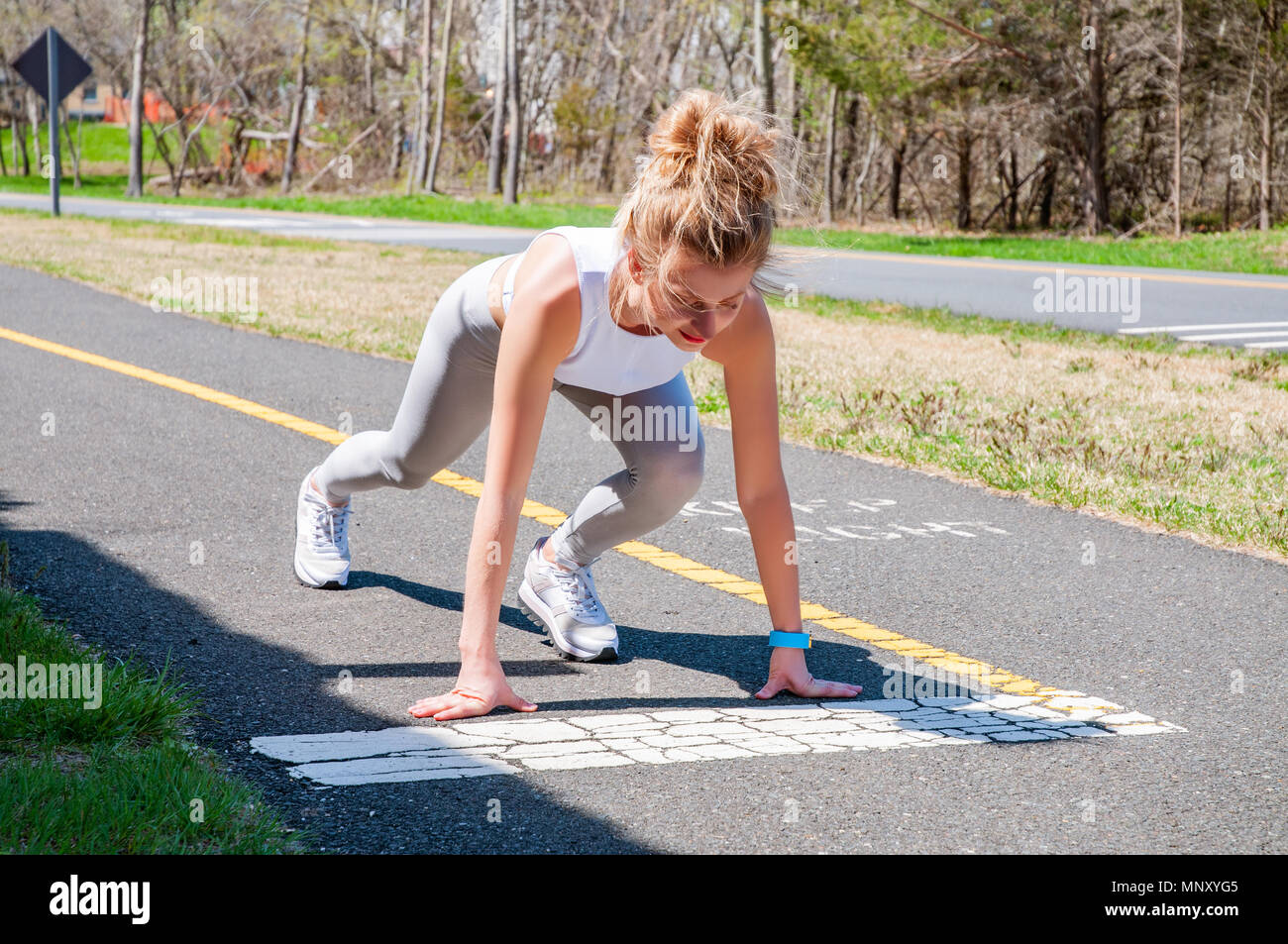Sprinter woman getting ready to start on the running track. Female ...