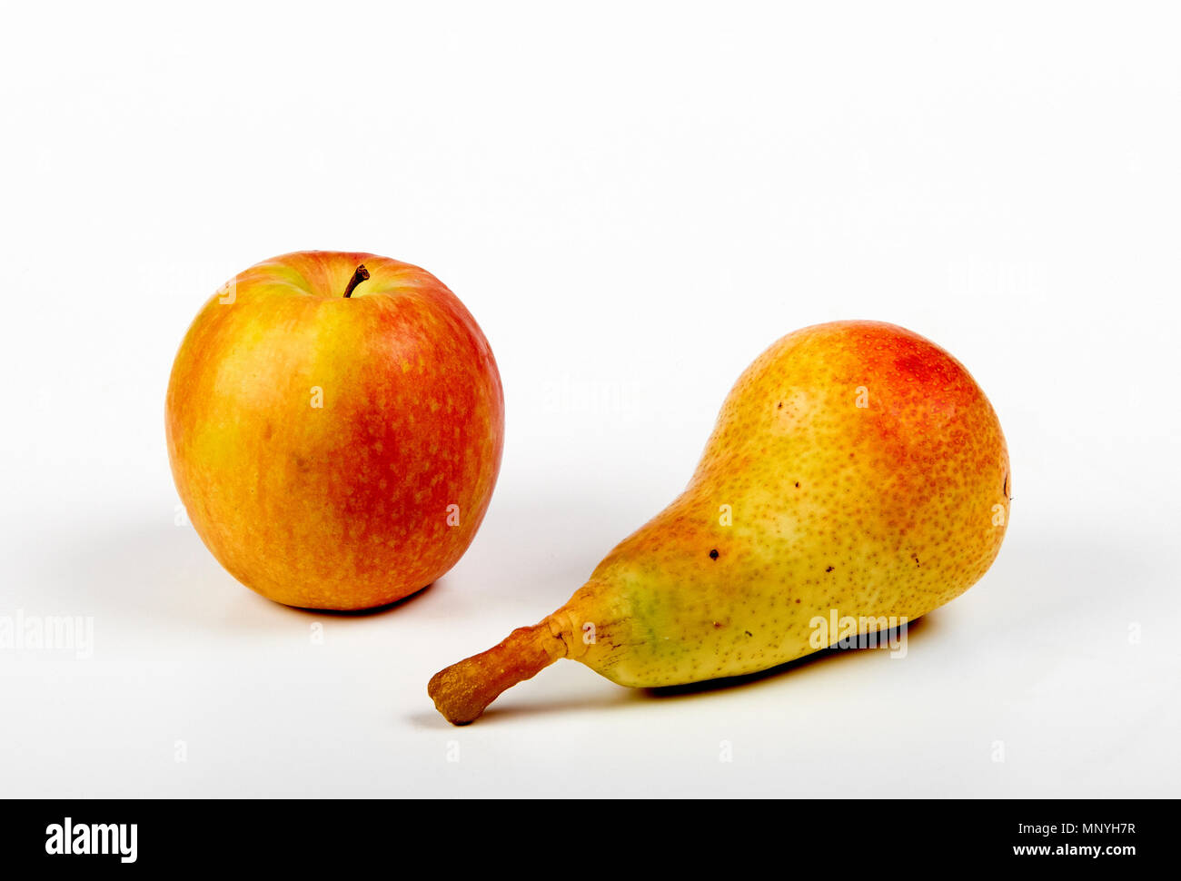 a pear and an apple on white background Stock Photo - Alamy