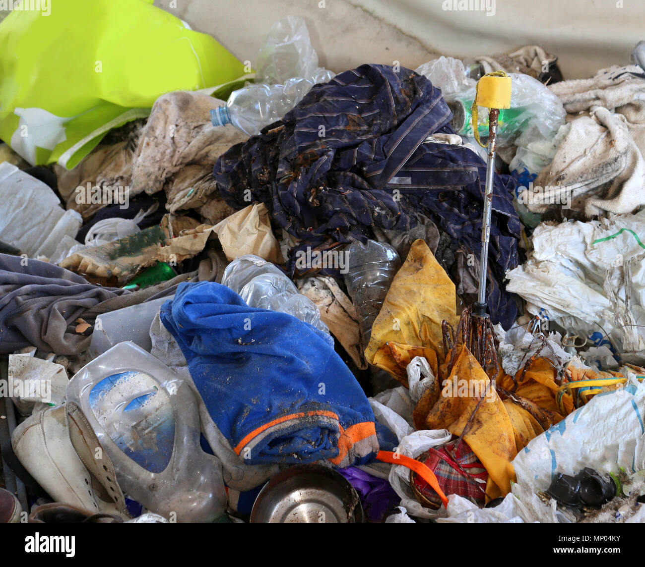broken yellow umbrella and many rags in the junkyard Stock Photo - Alamy
