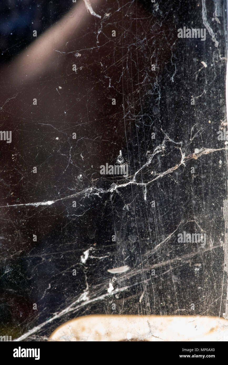 Spider webs in scratched window Stock Photo - Alamy