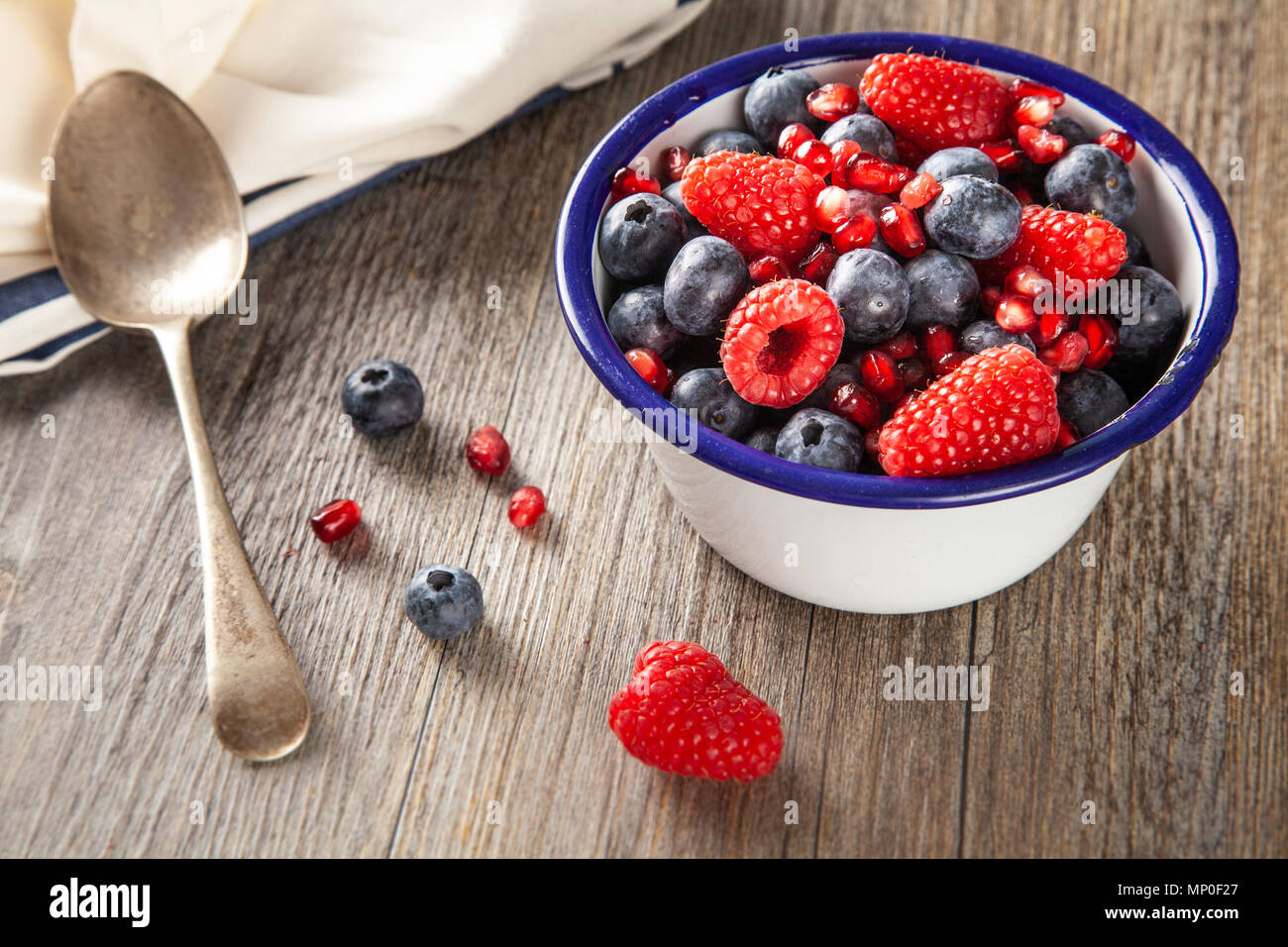 Selection of Forest fruits in a bowl with a spoon Stock Photo - Alamy