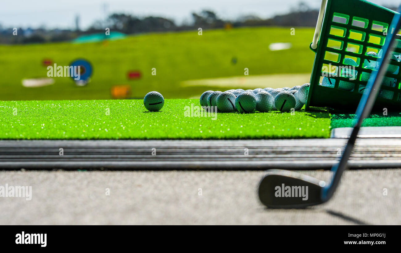Golf balls, basket of balls & Golf clubs at driving range images Stock ...