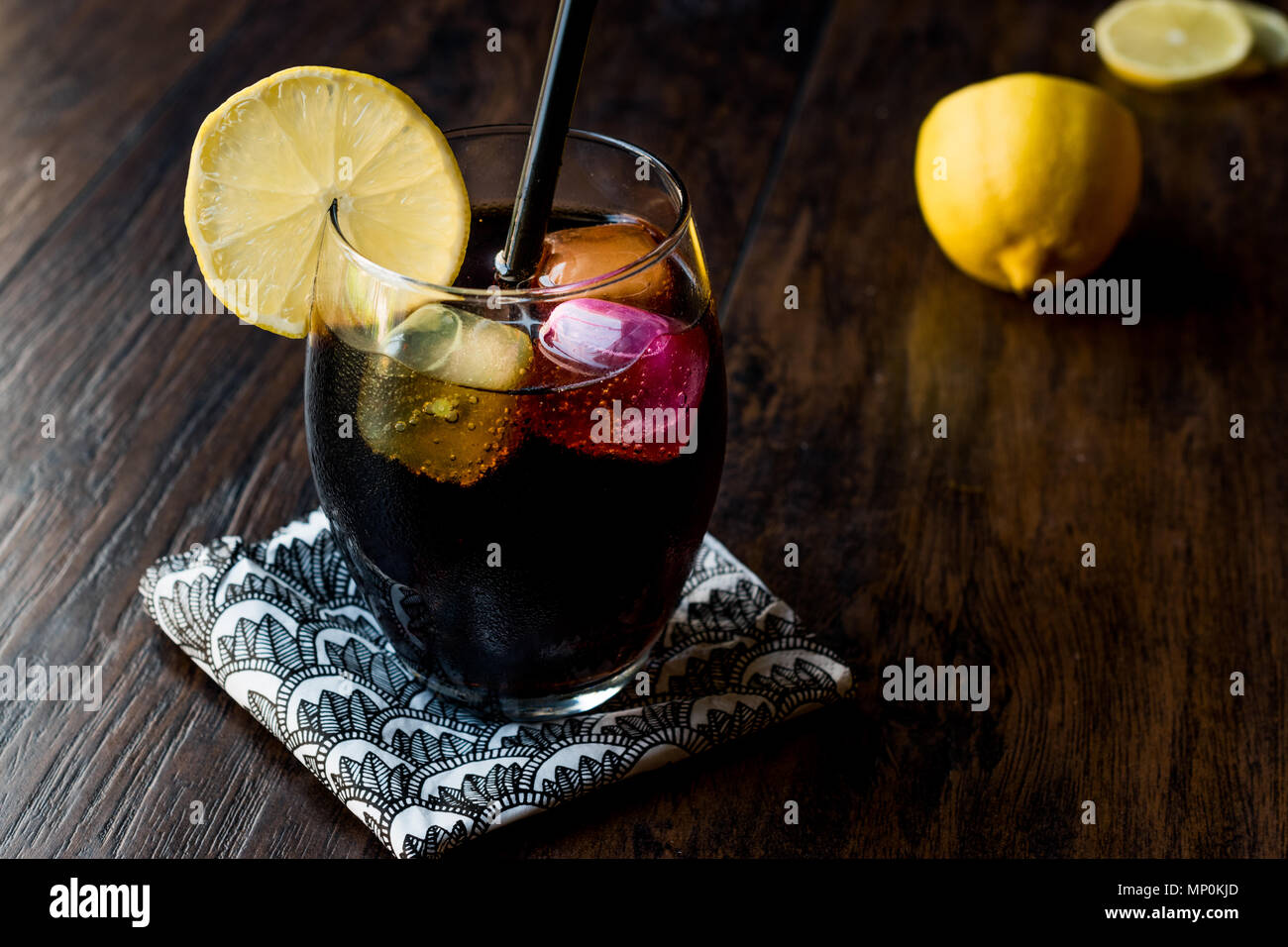 Black lemonade with charcoal, lemon and colorful bubble ice cubes ...