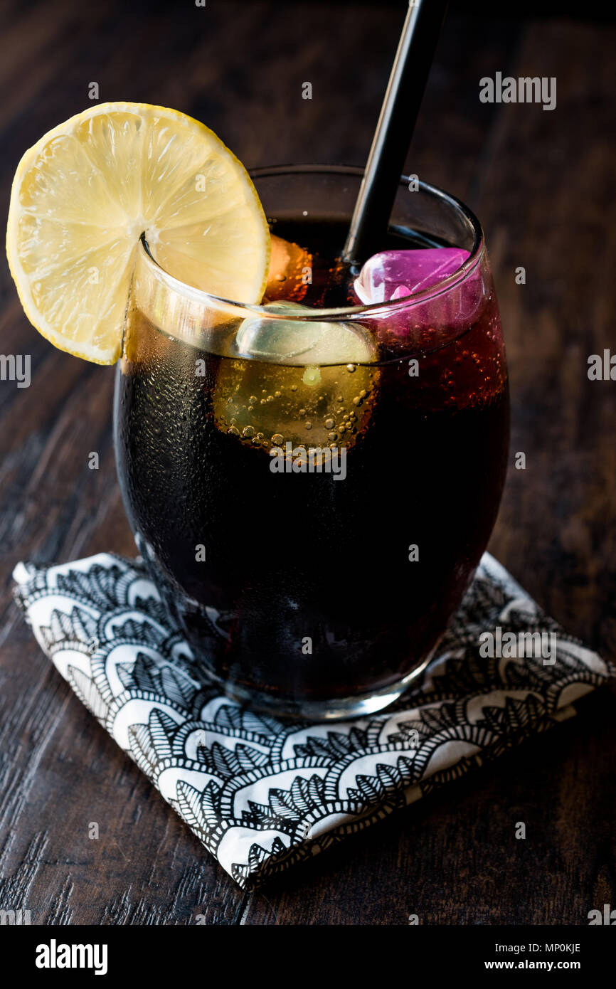 Black lemonade with charcoal, lemon and colorful bubble ice cubes ...