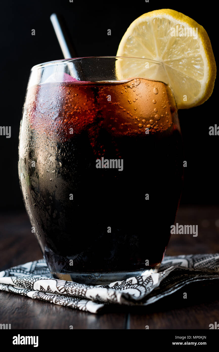 Black lemonade with charcoal, lemon and colorful bubble ice cubes ...