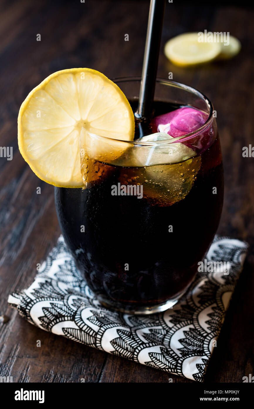 Black lemonade with charcoal, lemon and colorful bubble ice cubes ...